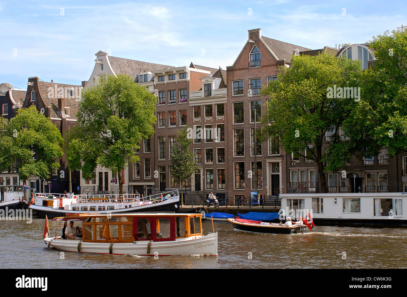 small motor boats in a water channel, Netherlands, Amsterdam Stock ...