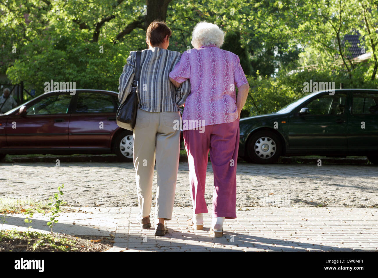 Helping elderly cross street hi-res stock photography and images - Alamy