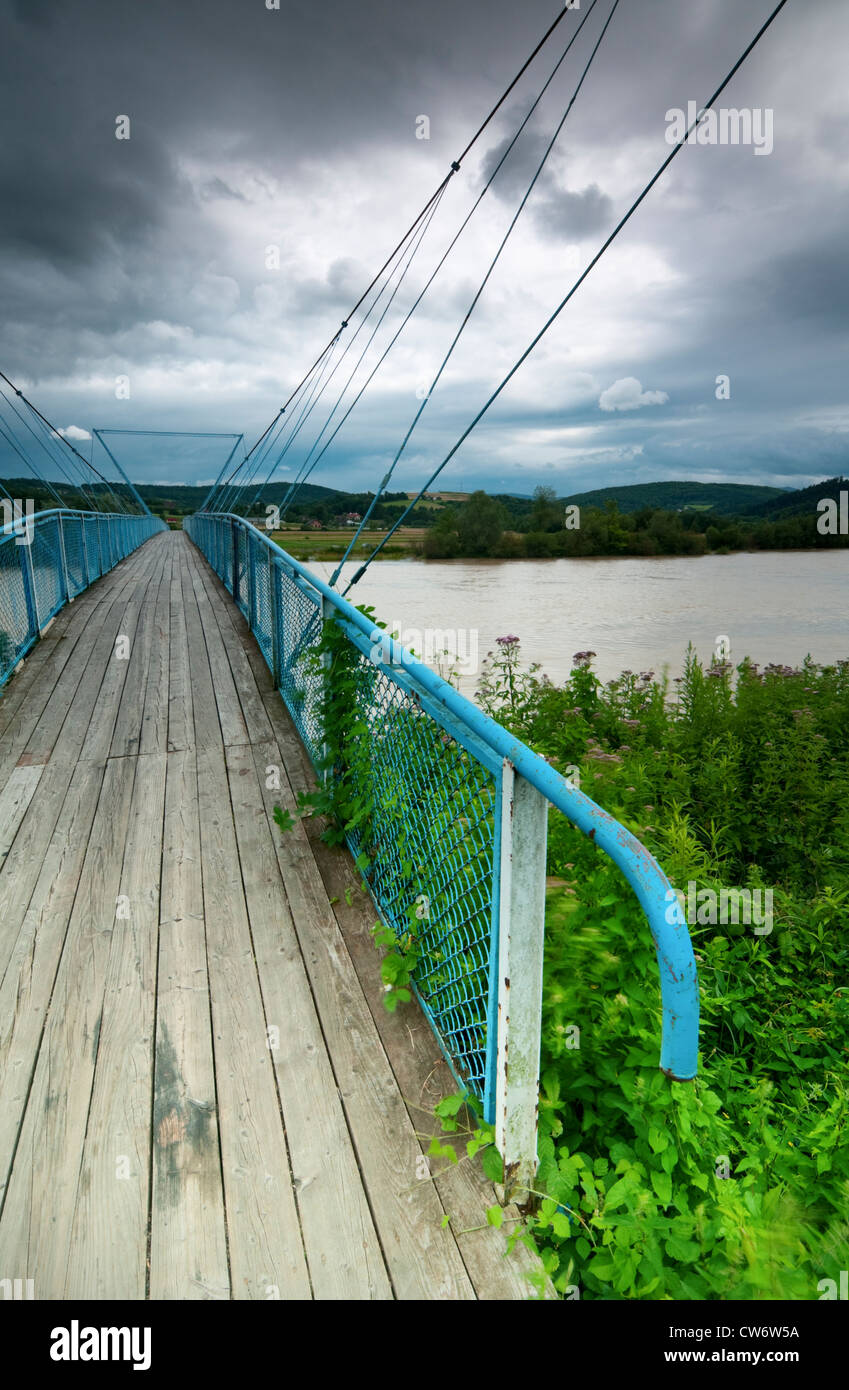 Bridge over brown river in countryside Stock Photo - Alamy