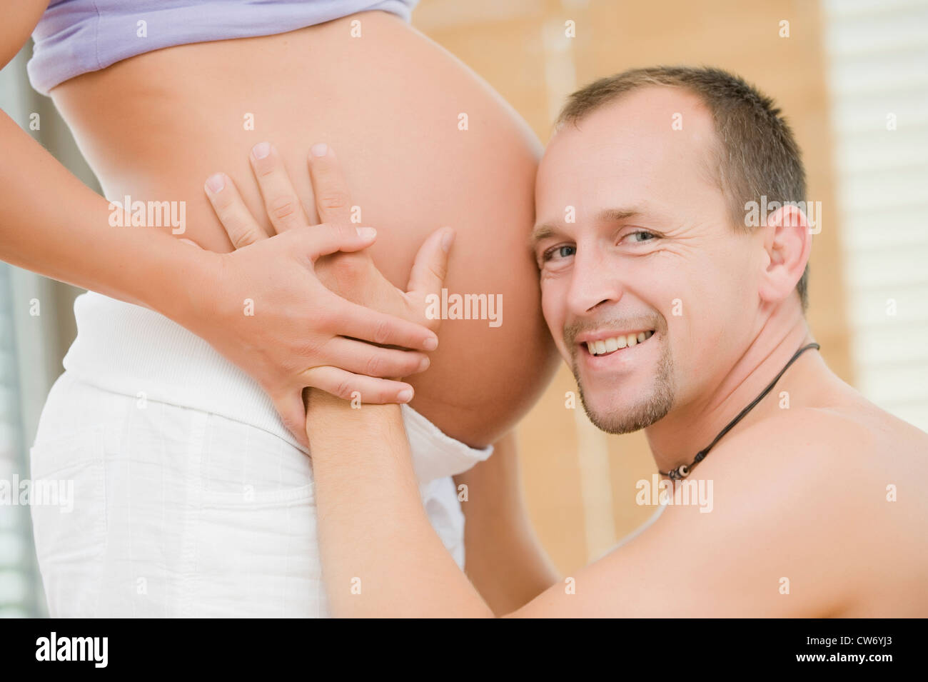 expectant father with baby belly Stock Photo - Alamy