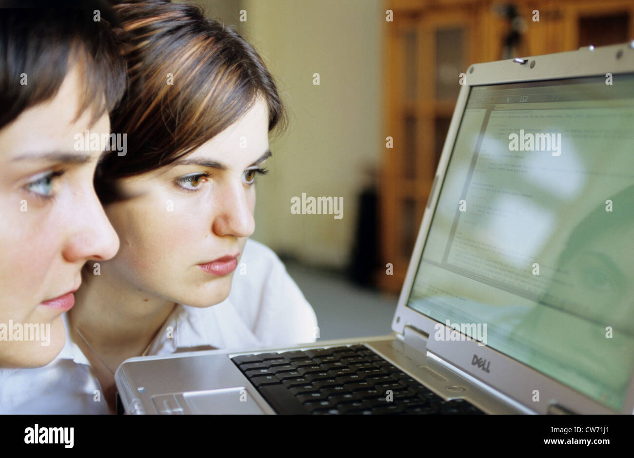 two ladies with a notebook Stock Photo - Alamy