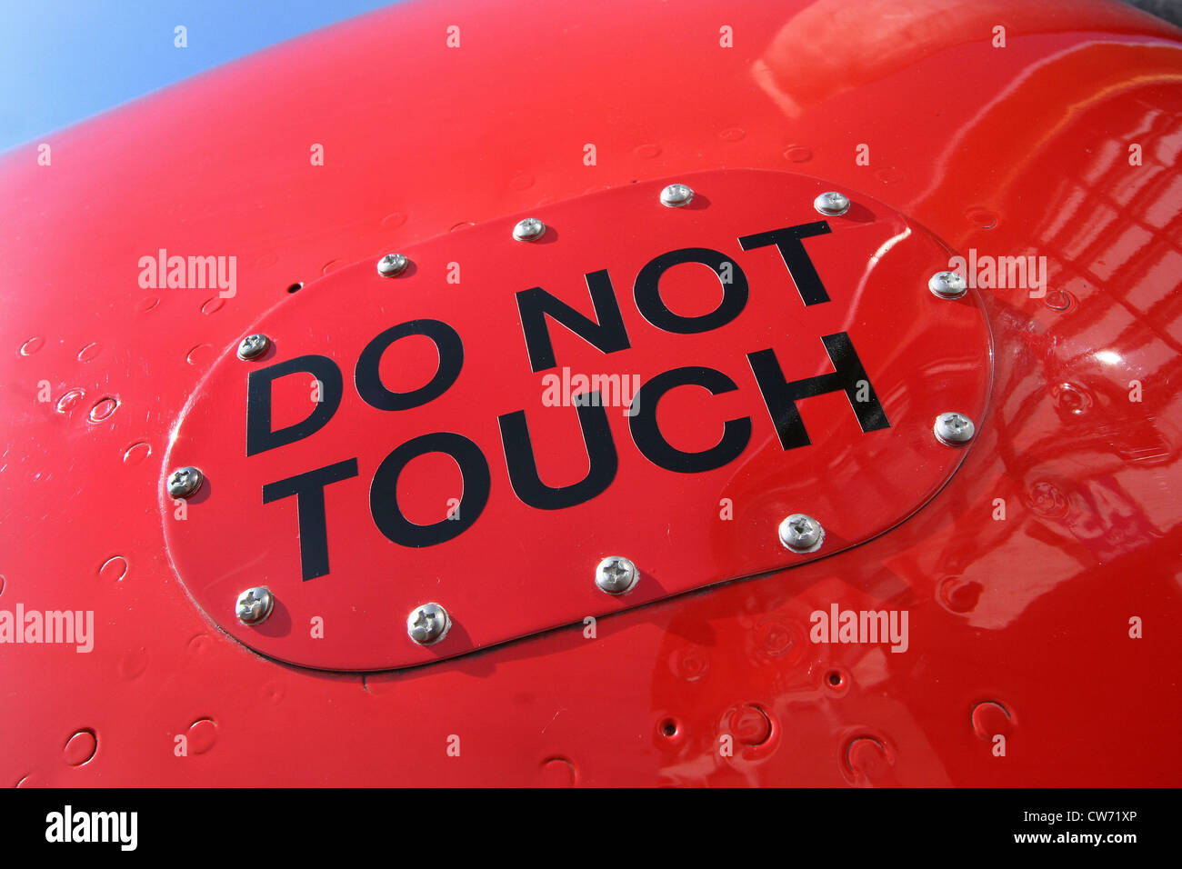 metal sign at a plane saying 'DO NOT TOUCH' Stock Photo - Alamy