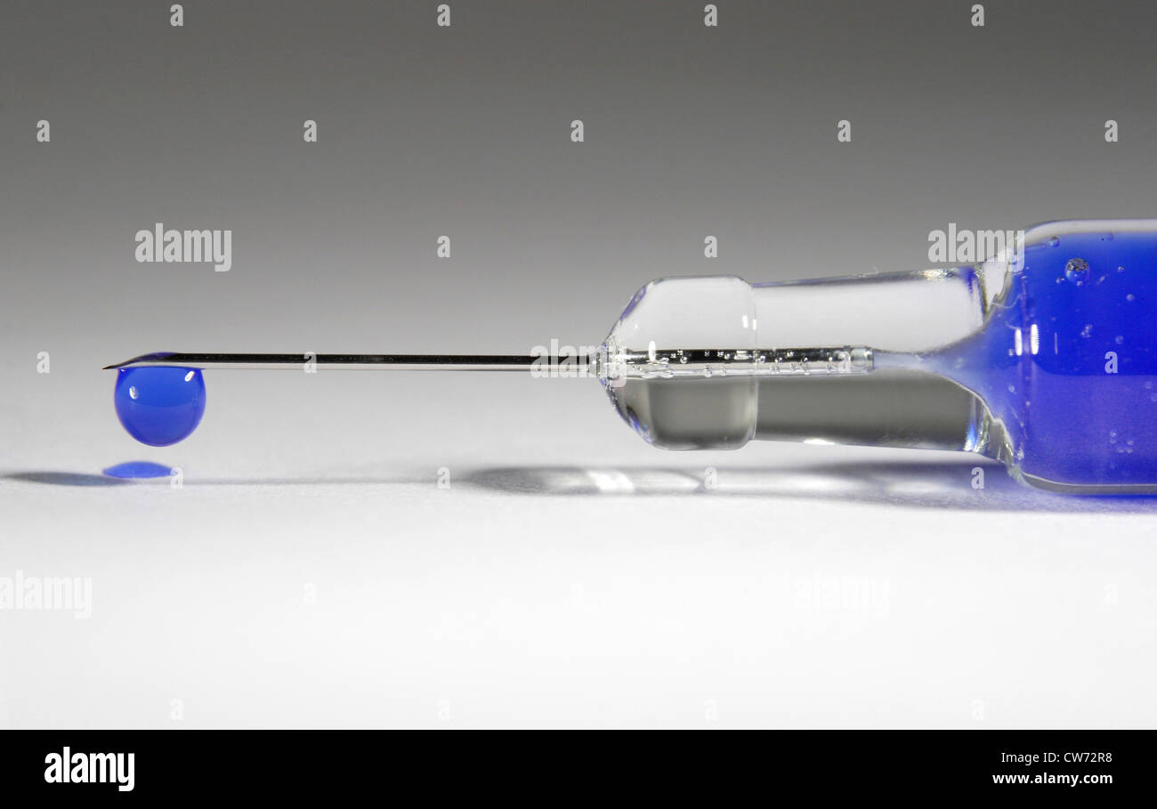 injection with blue liquid and a drop at the tip of the needle Stock ...