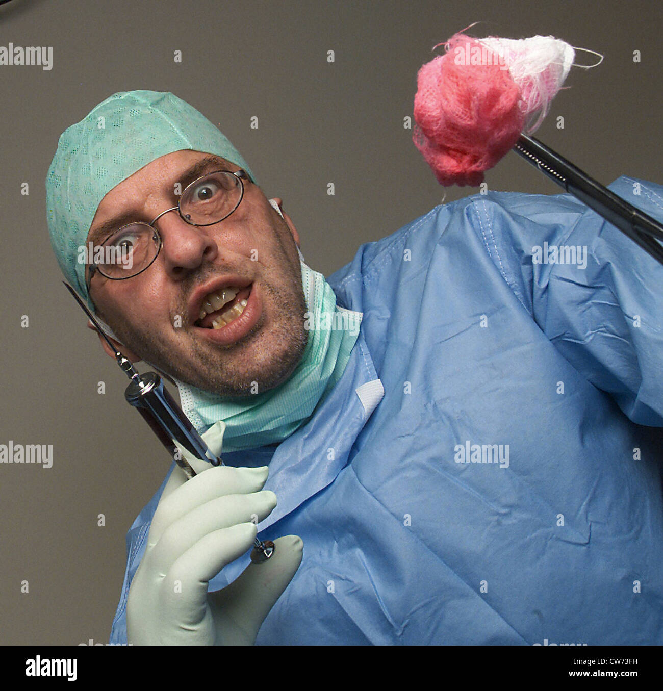 surgeon with bloody swab and syringe Stock Photo - Alamy