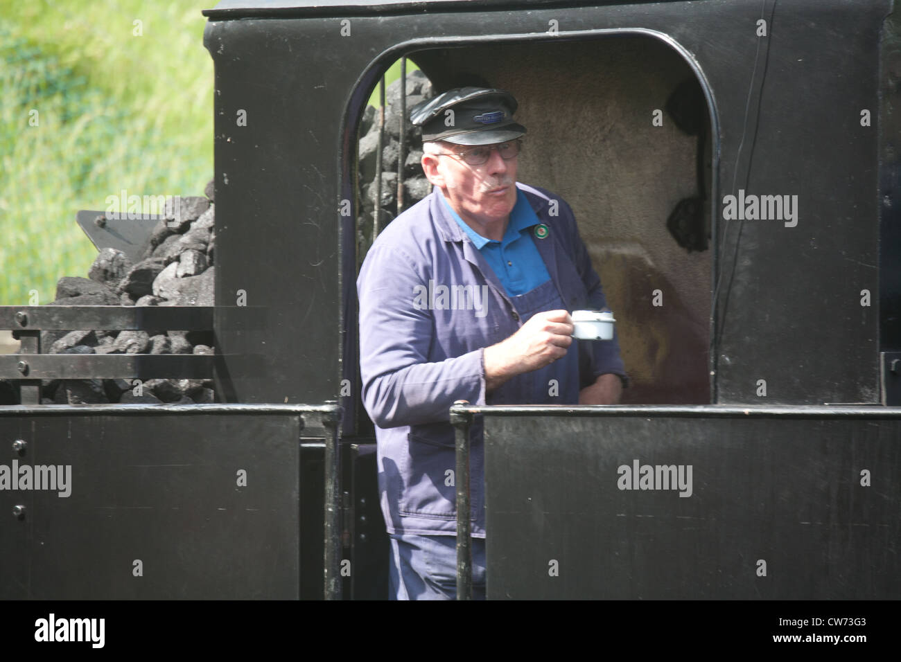 Great Central Railway Train Driver with Tea Mug Stock Photo - Alamy