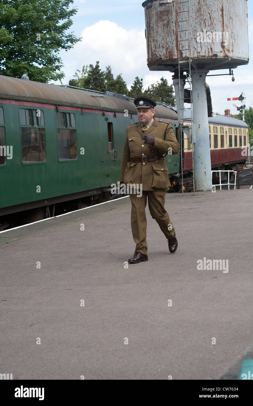 Home Guard Office walking along platform with train Stock Photo - Alamy