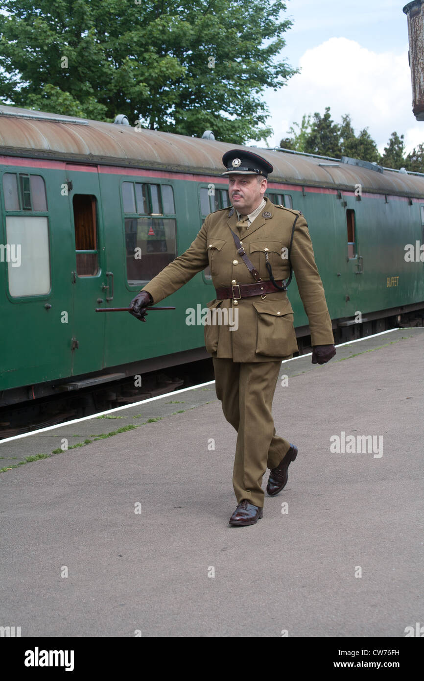 Home Guard Office walking along platform with train Stock Photo - Alamy