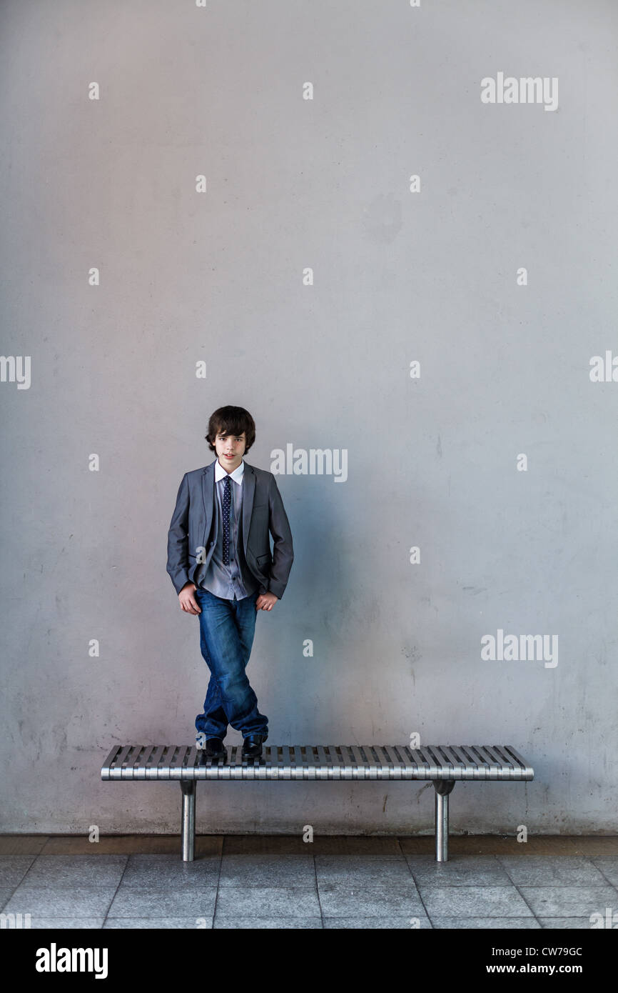 Young teenager boy standing on a bench Stock Photo - Alamy