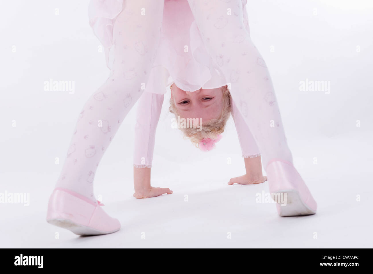 little ballet girl looking through her legs Stock Photo - Alamy