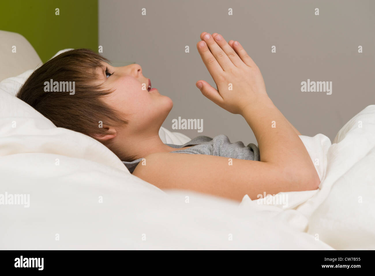 boy is praying in bed Stock Photo - Alamy