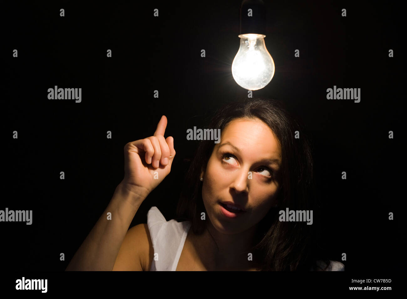 shining electric bulb over a young woman's head symbolising Stock Photo ...
