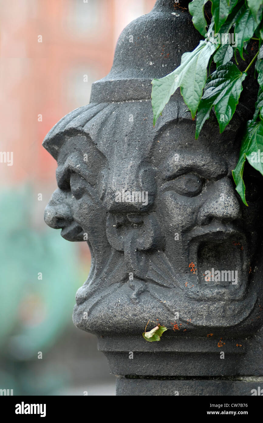 two stone faces at a statue at the Kopenhagen Town Hall Place, Denmark ...