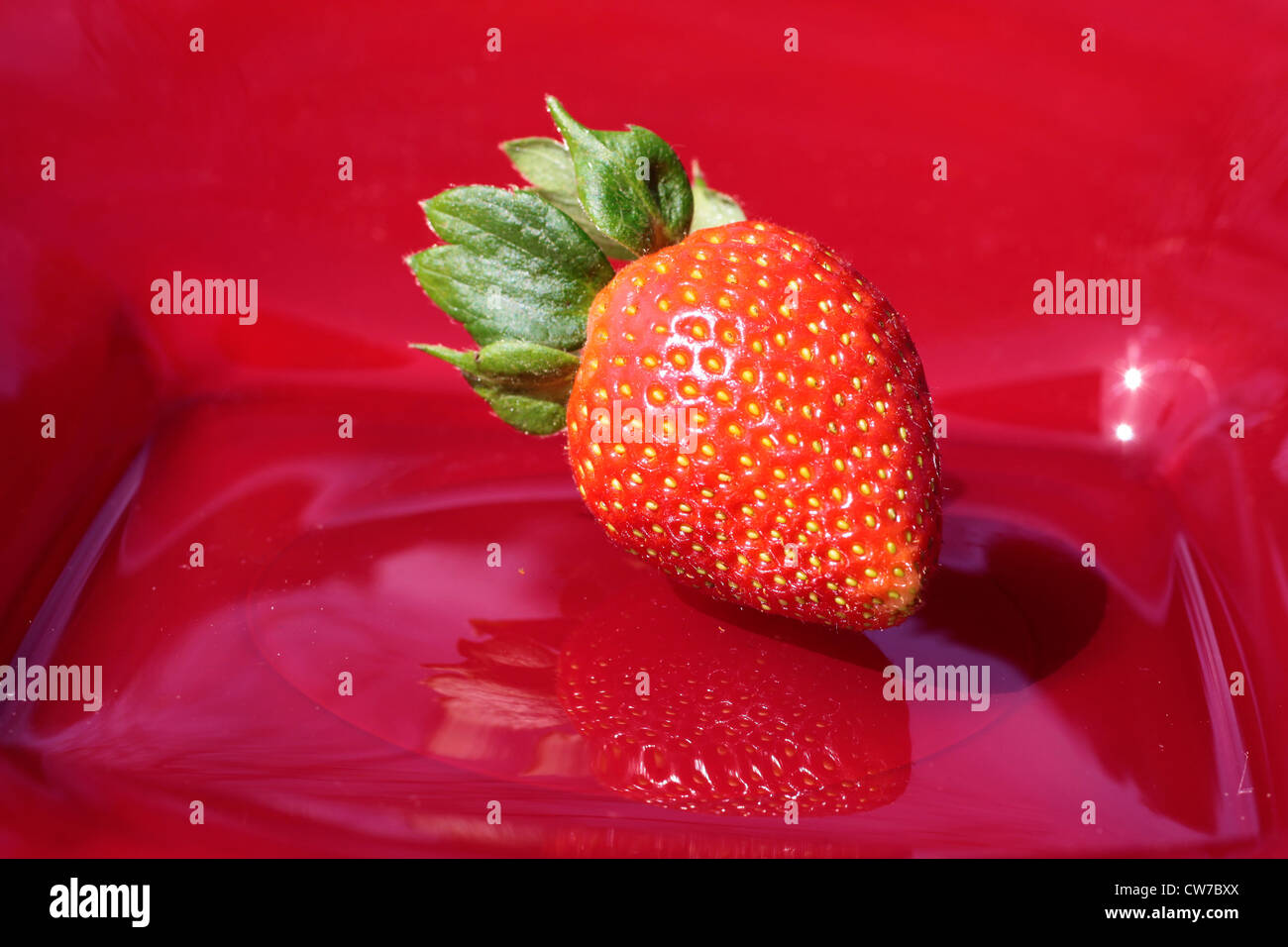 Perfect Strawberry in a red bowl Stock Photo - Alamy