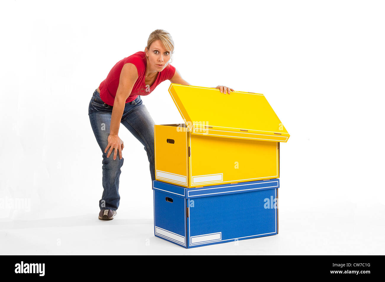 young woman opening a box and looking surprised Stock Photo - Alamy