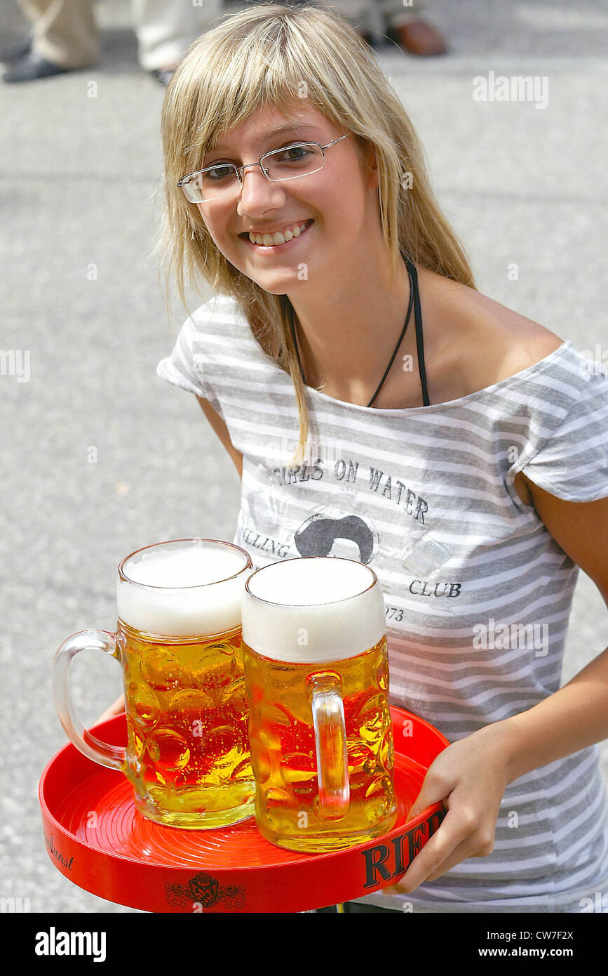 waitress with beer on a tray Stock Photo - Alamy
