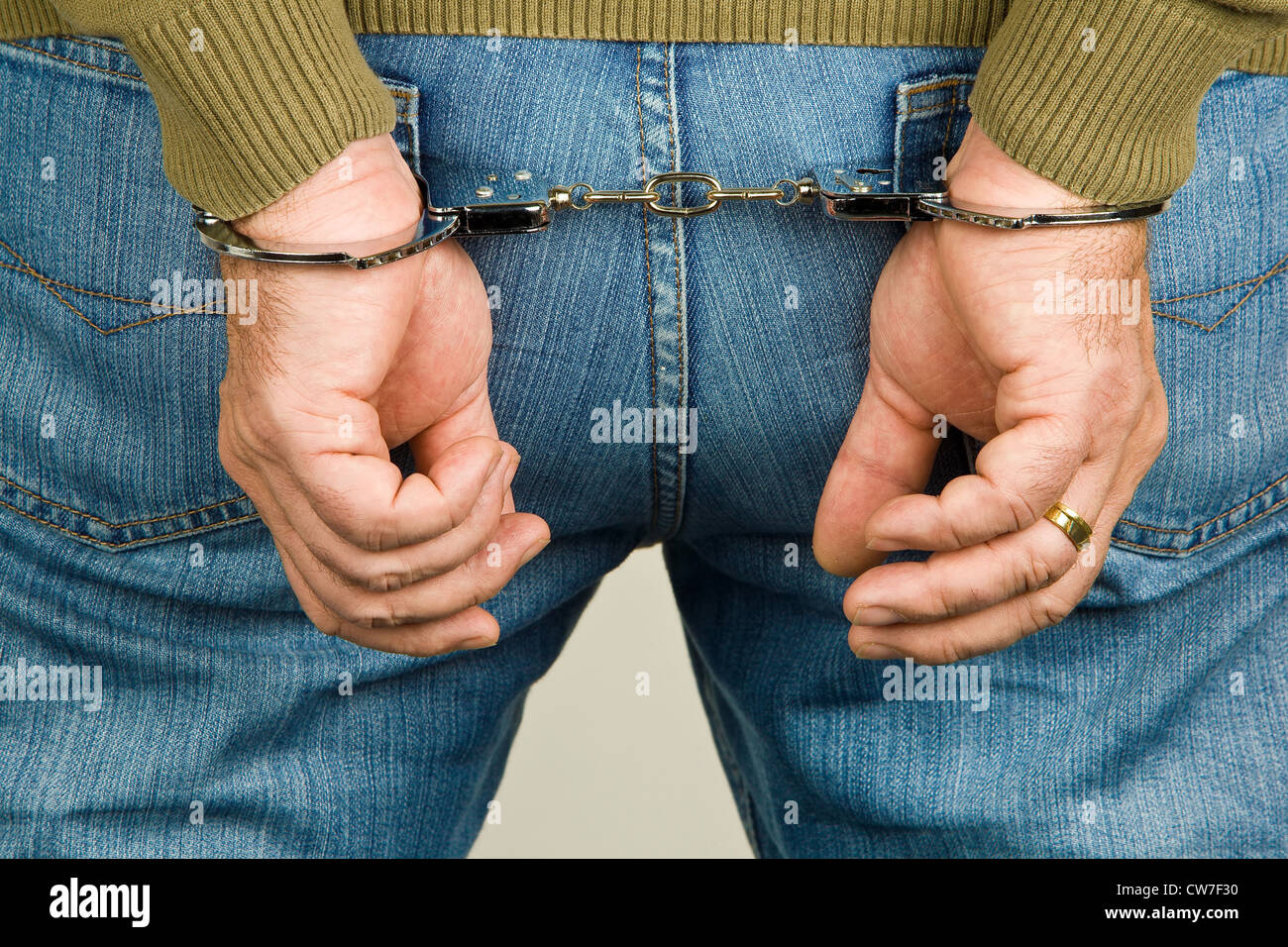 Closeup of hands in handcuffs Stock Photo - Alamy
