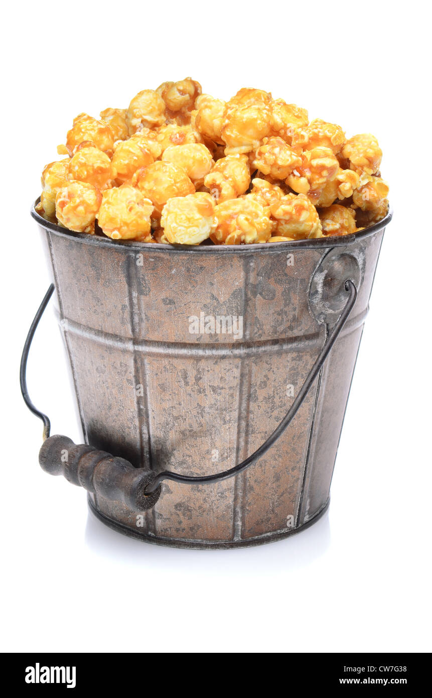 A old fashioned bucket of caramel corn over a white background with ...