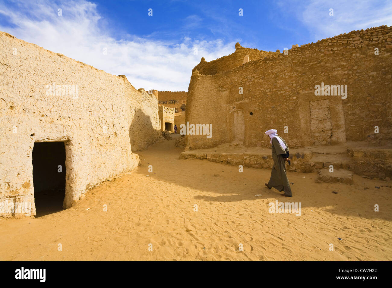 alleys with simple stone houses and sand ground at the old town, Libya ...