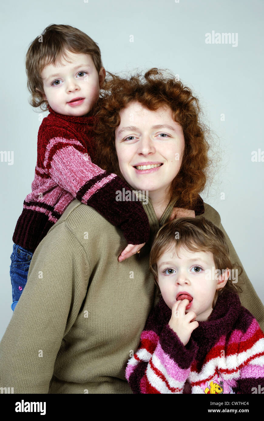 portrait of a mother with her twins Stock Photo - Alamy