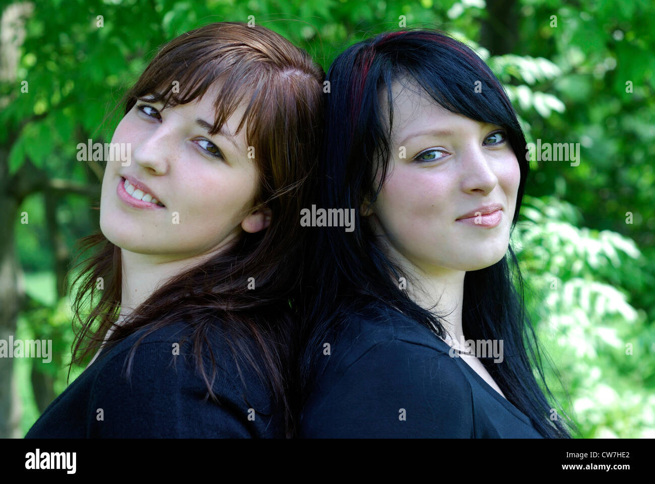 two girlfriends, back to back Stock Photo - Alamy