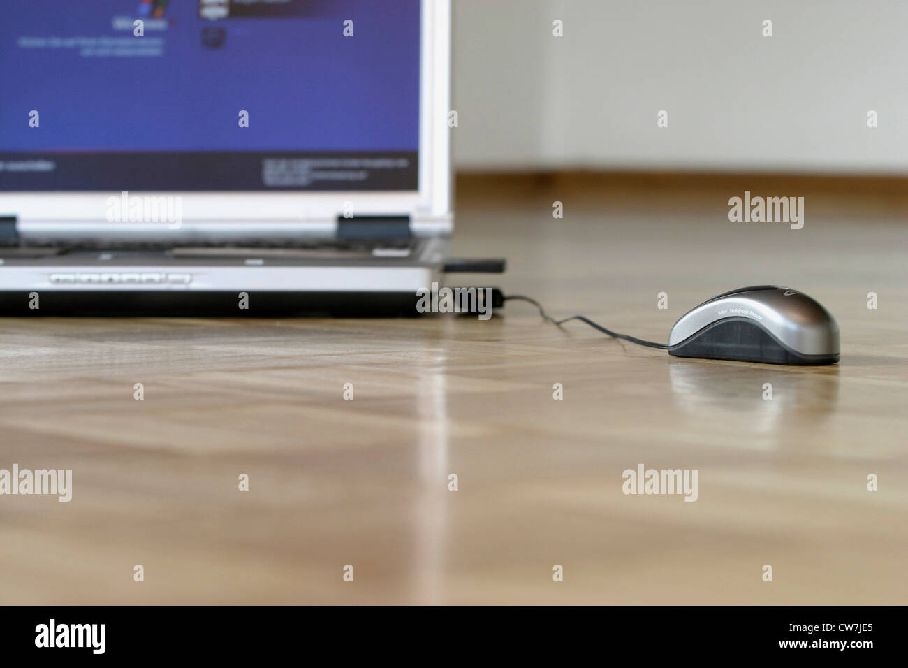 laptop and computer mouse on the floor Stock Photo - Alamy