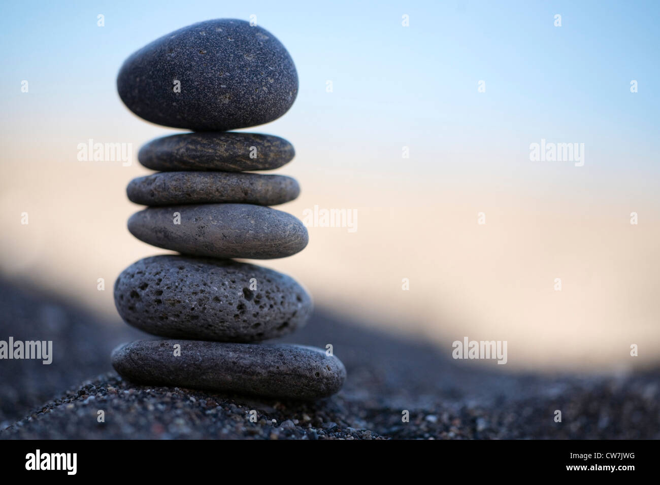 Balanced Stones. Stack of volcanic pebbles on seashore Stock Photo - Alamy