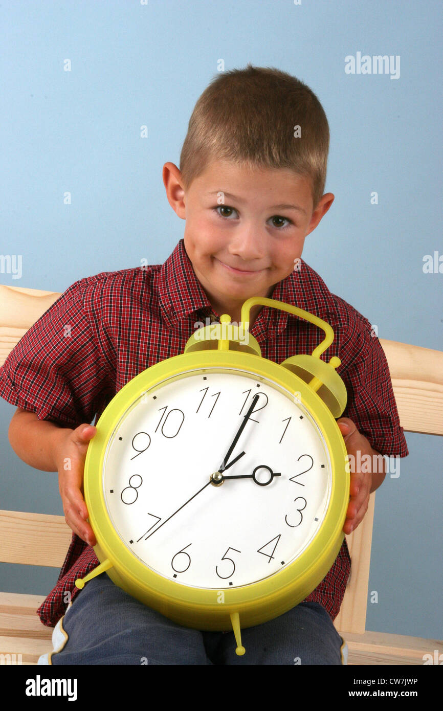 little boy with big alarm clock Stock Photo - Alamy
