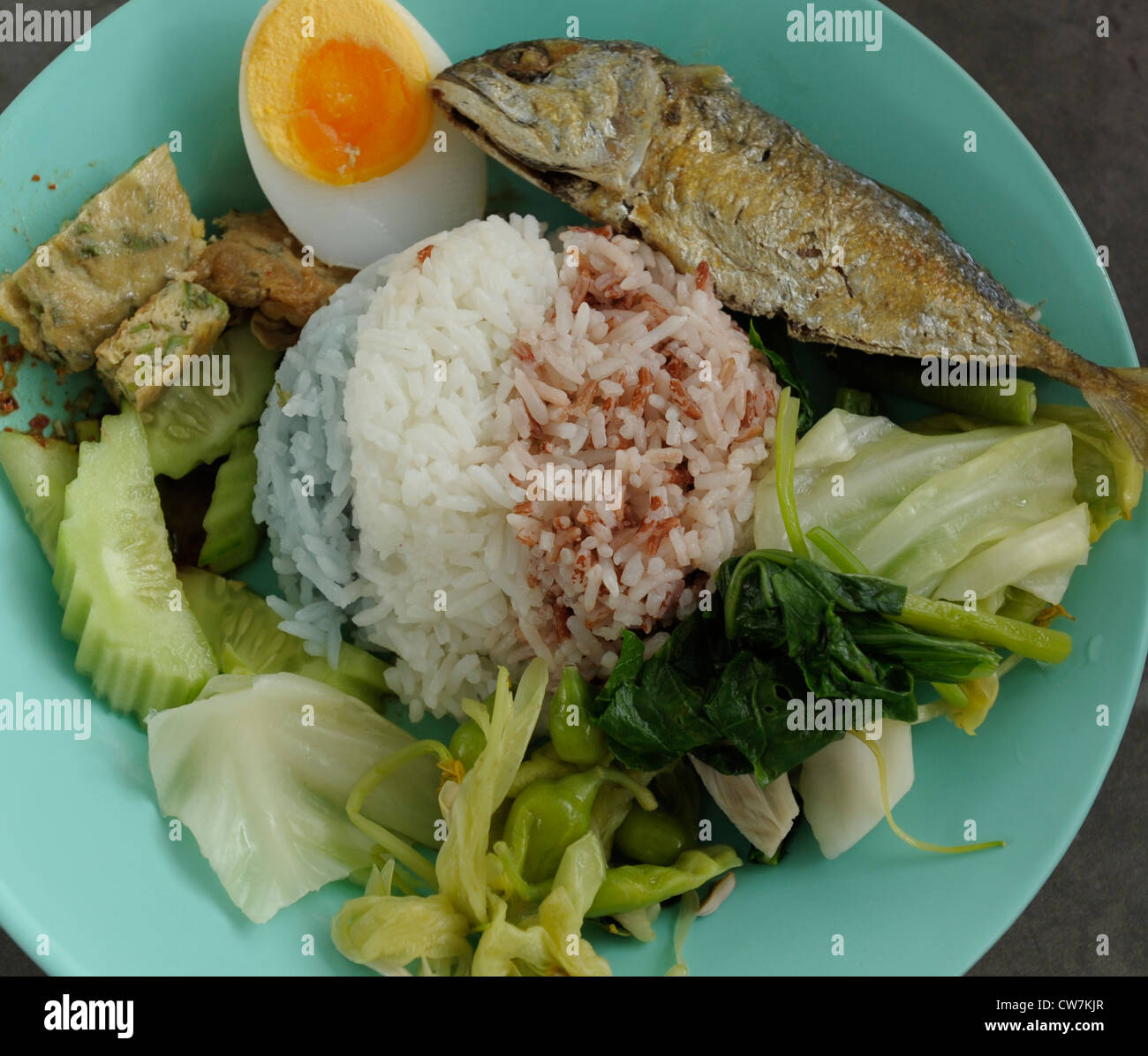 multi color rice served with two head fish and mix vegetable,thai ...