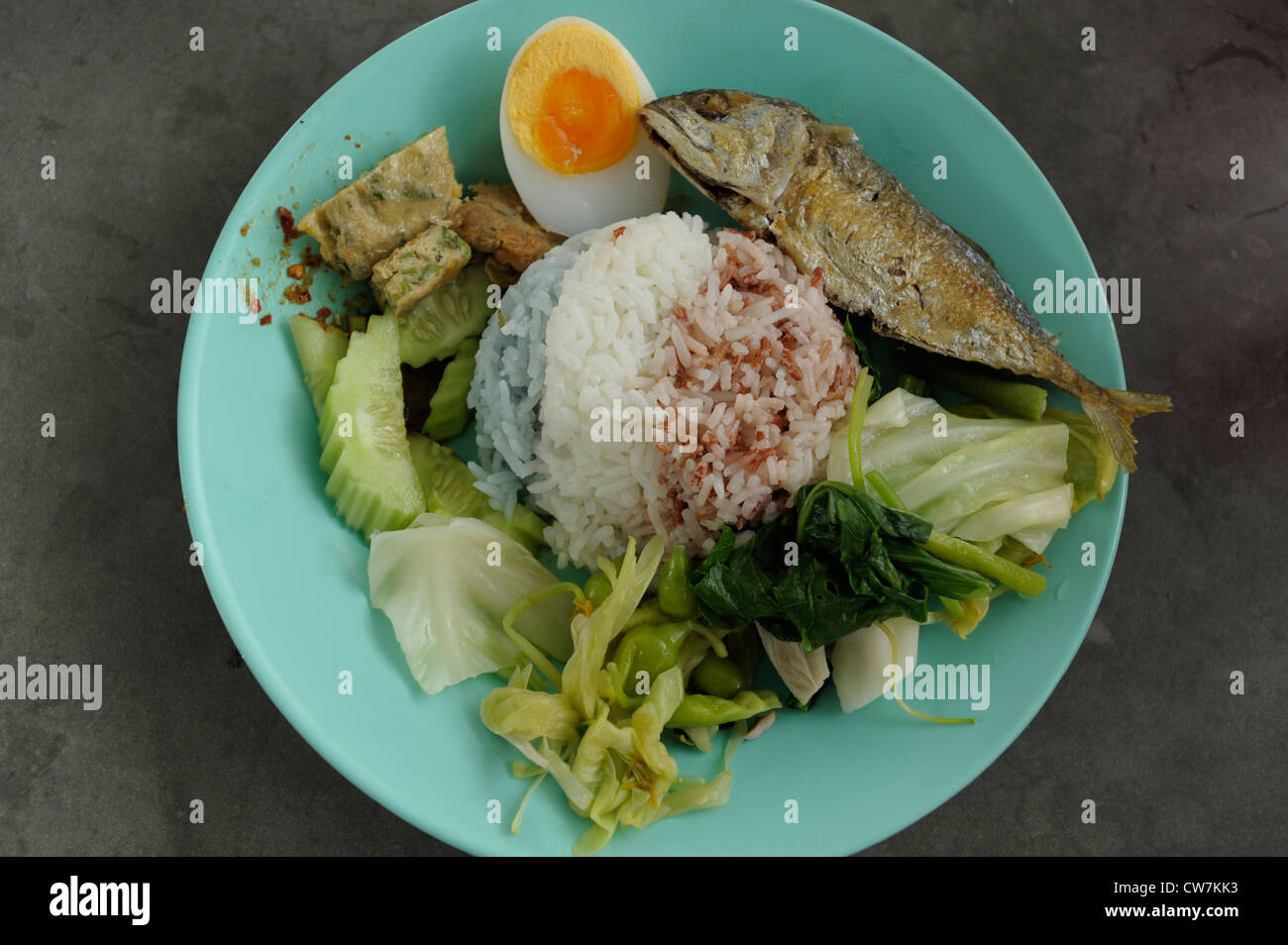 multi color rice served with two head fish and mix vegetable,thai ...