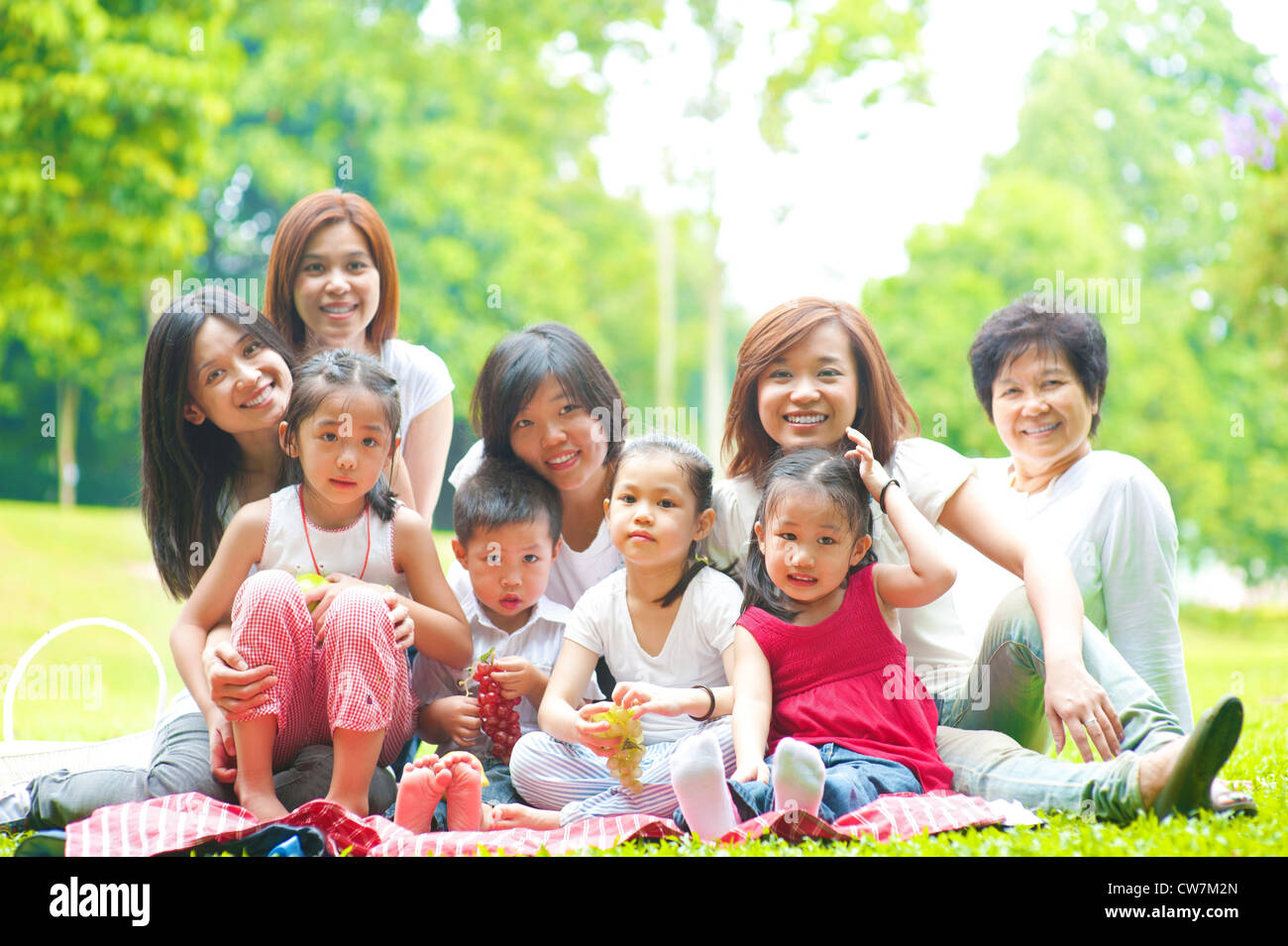 Happy Asian family enjoying picnic at outdoor park Stock Photo - Alamy