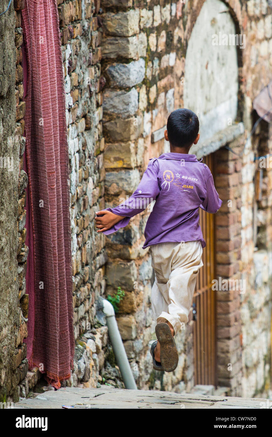 Boy running in a narrow alley in Said Pur Village, Islamabad, Pakistan ...