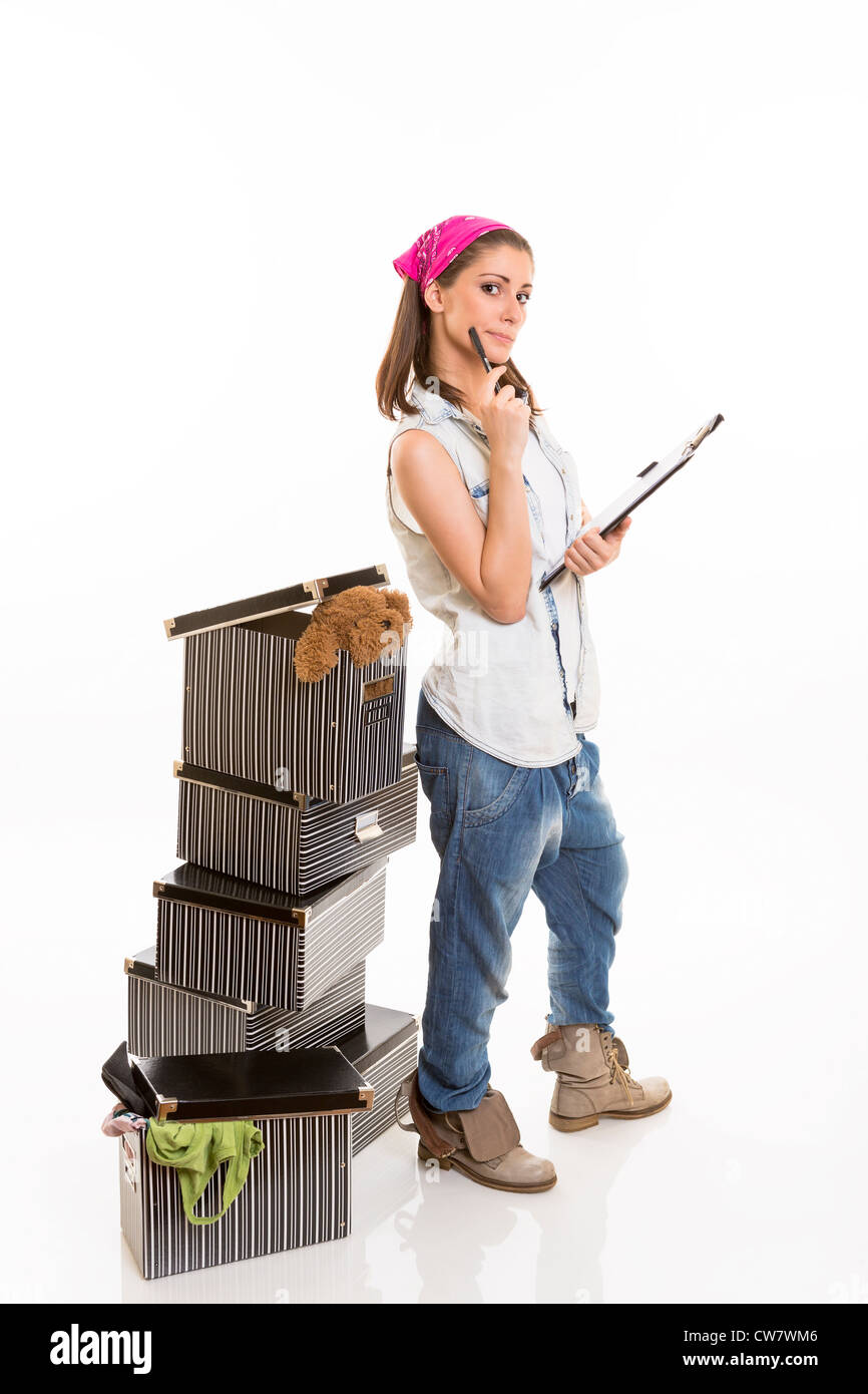 Casual dressed woman keeping track of packed stuff on her board ...