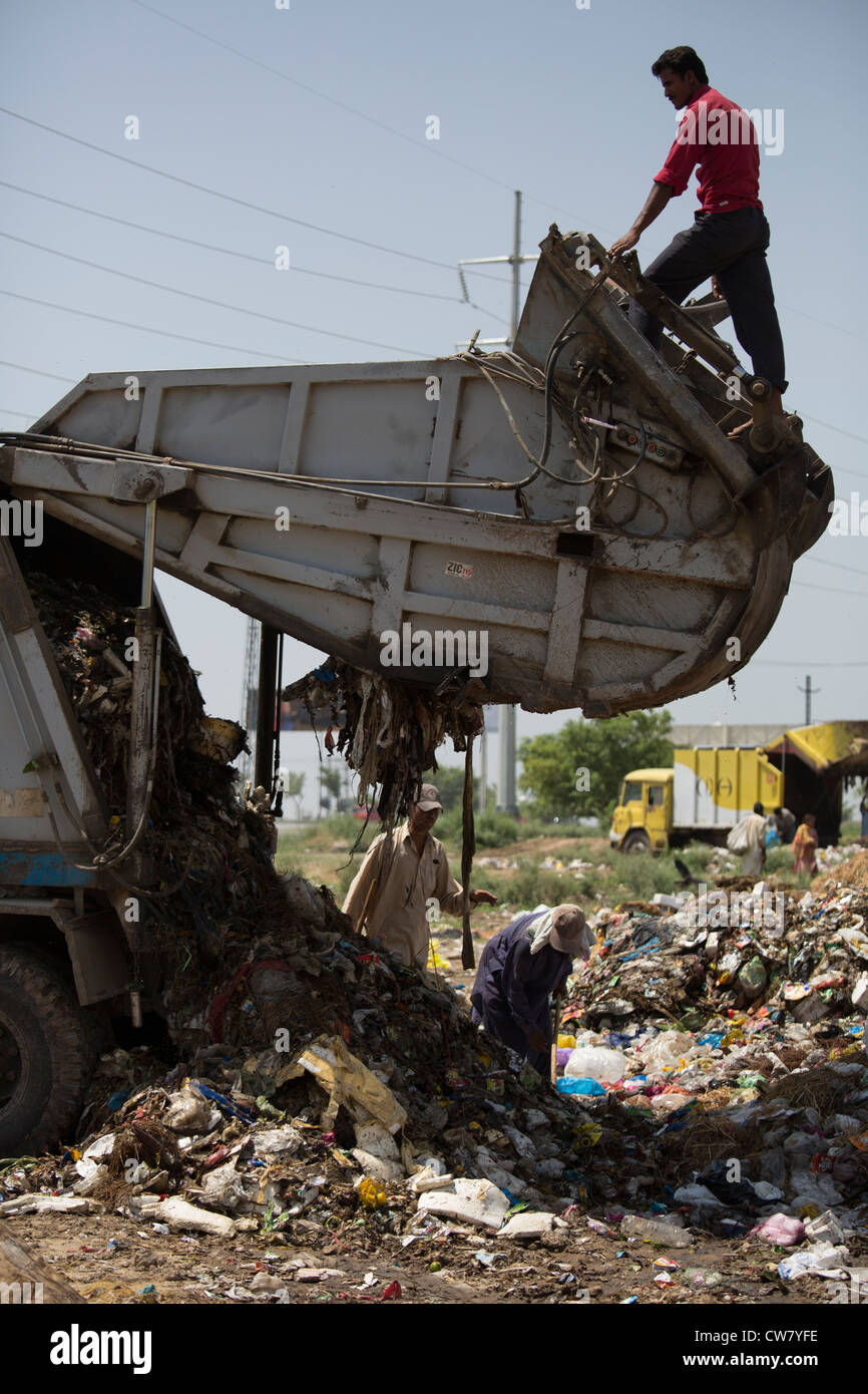 Man emptying garbage waste landfill hi-res stock photography and images ...