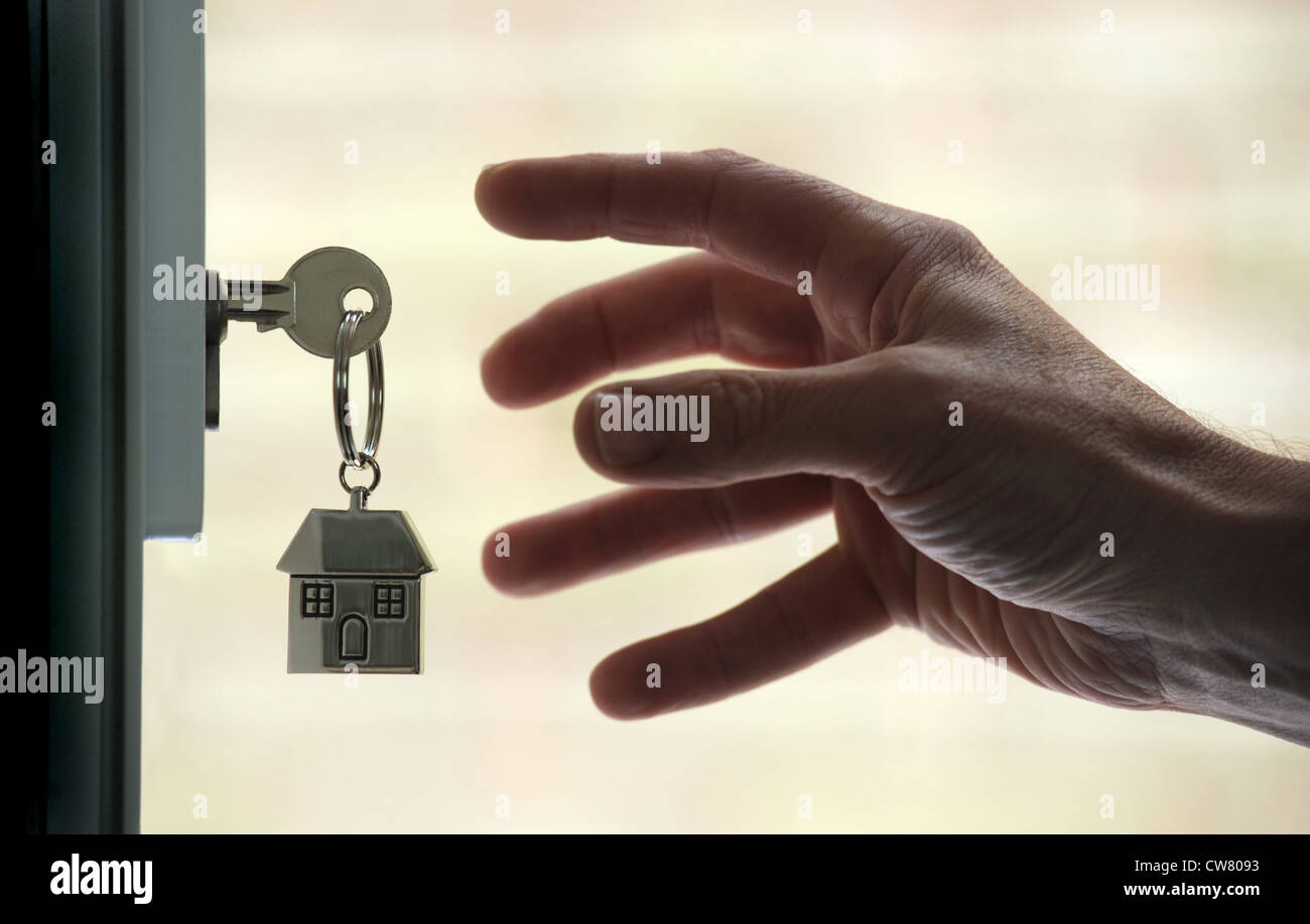 MANS HAND REACHING FOR HOUSE KEY AND FOB IN DOOR RE HOME BUYERS FIRST ...