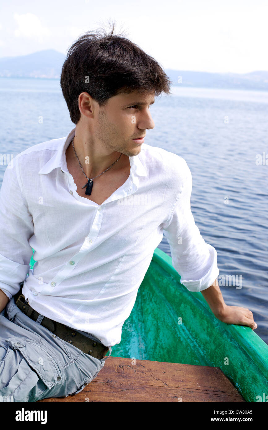 Medium shot of serious good looking man on green boat Stock Photo - Alamy