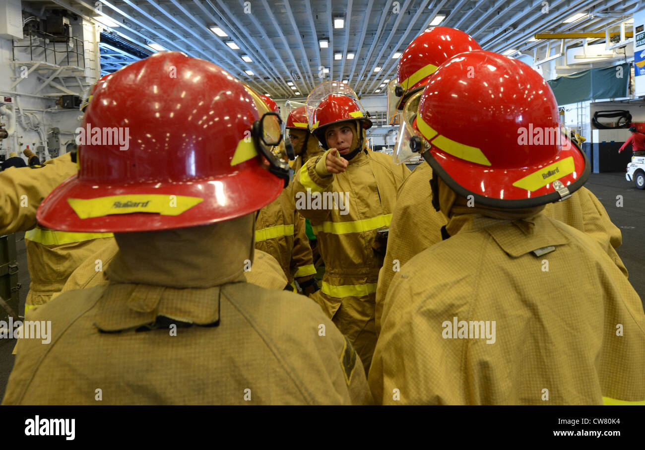 Sailors prepare for a firefighting simulation during a General Quarters ...