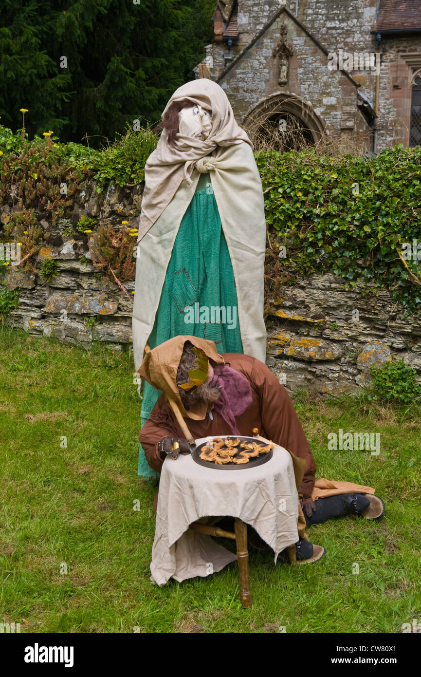 Effigies of medieval characters outside church at village fete on ...