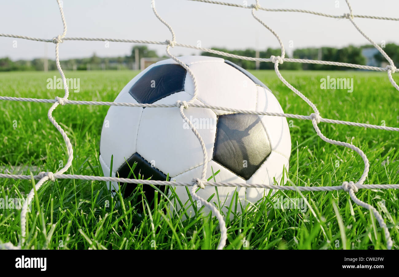 Classic football in the goal net Stock Photo - Alamy
