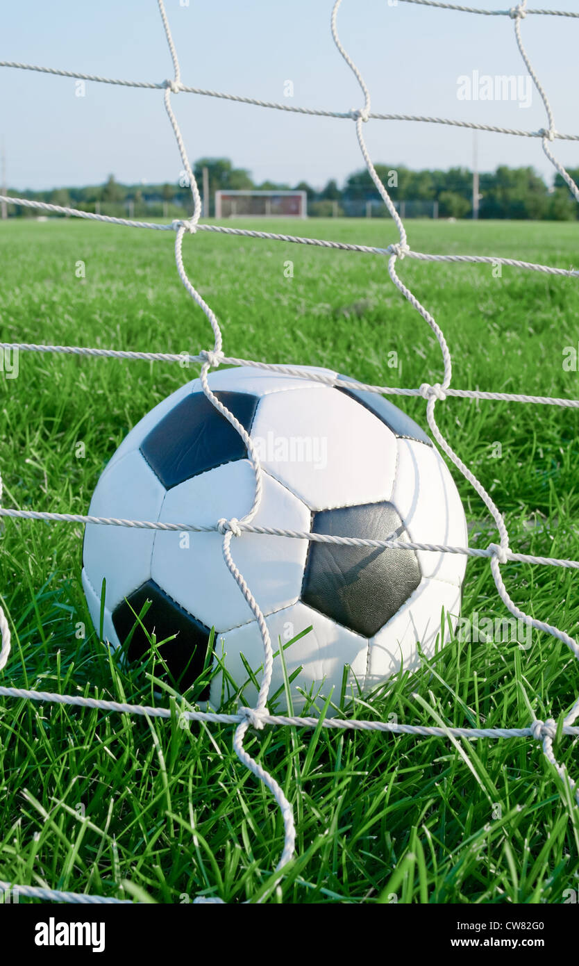 Classic football in the goal net Stock Photo - Alamy