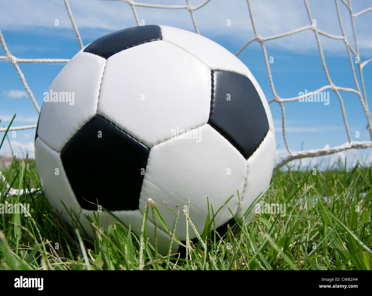 Classic football in the goal net Stock Photo - Alamy