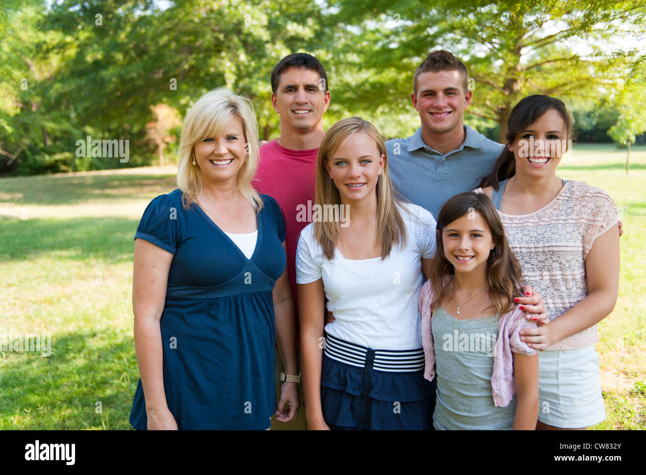 Family of six outside smiling together Stock Photo - Alamy