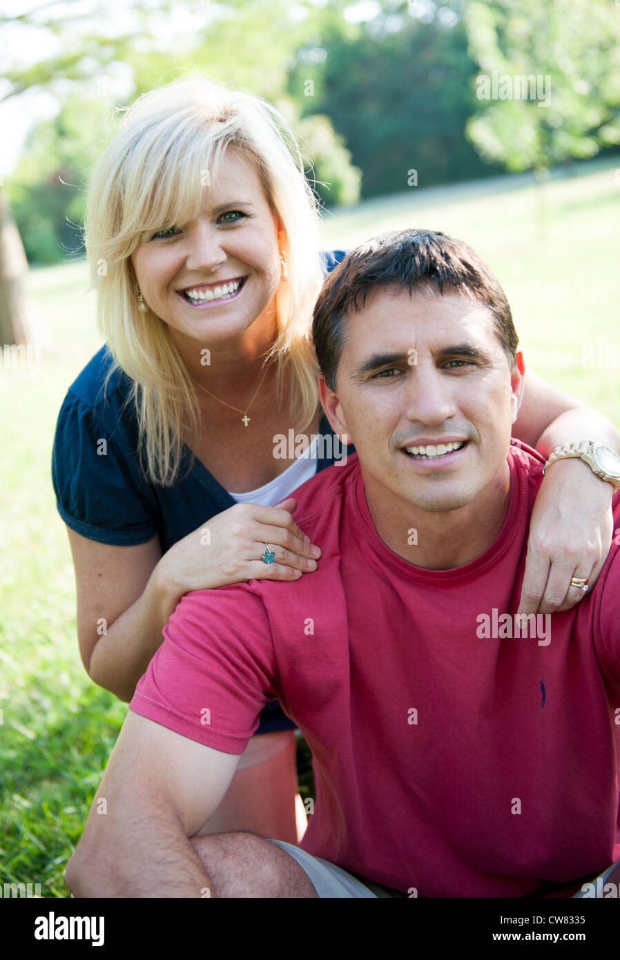 Married couple outside smiling Stock Photo - Alamy