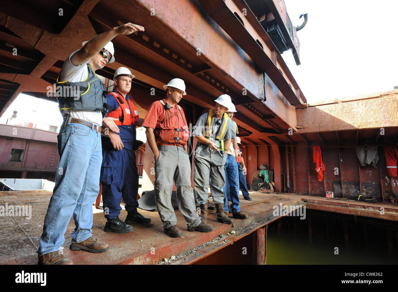 Todd Schauer, a project manager with Resolve Marine Group talks with ...