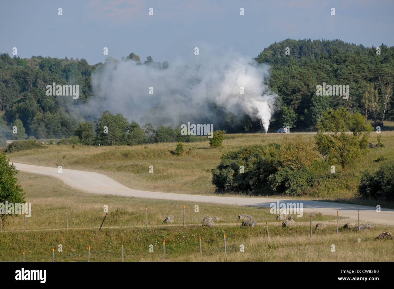 A simulated improvised explosive device detonates as a vehicle ...