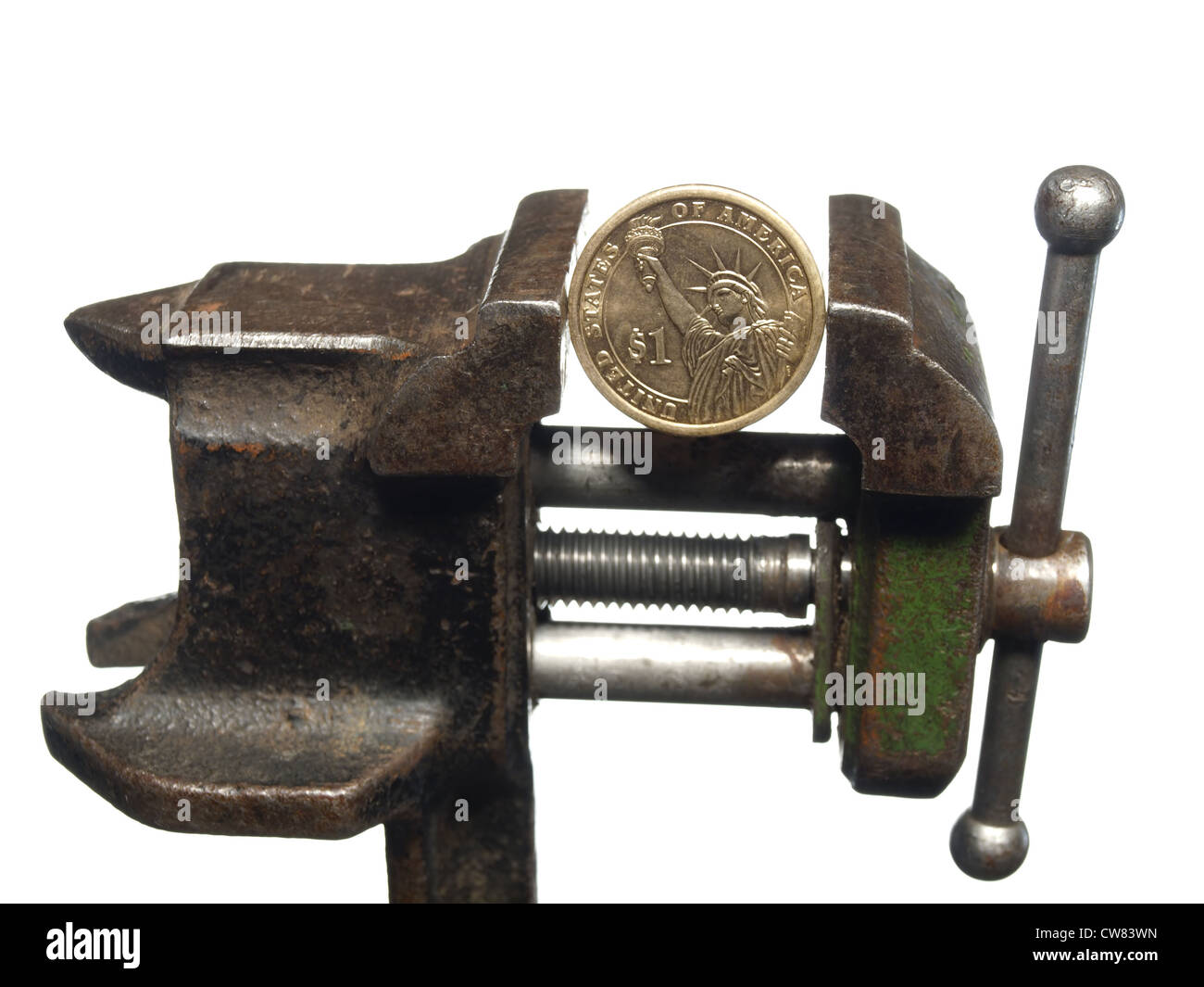 Coin one dollar is clamped in the old vice, isolated on a white ...