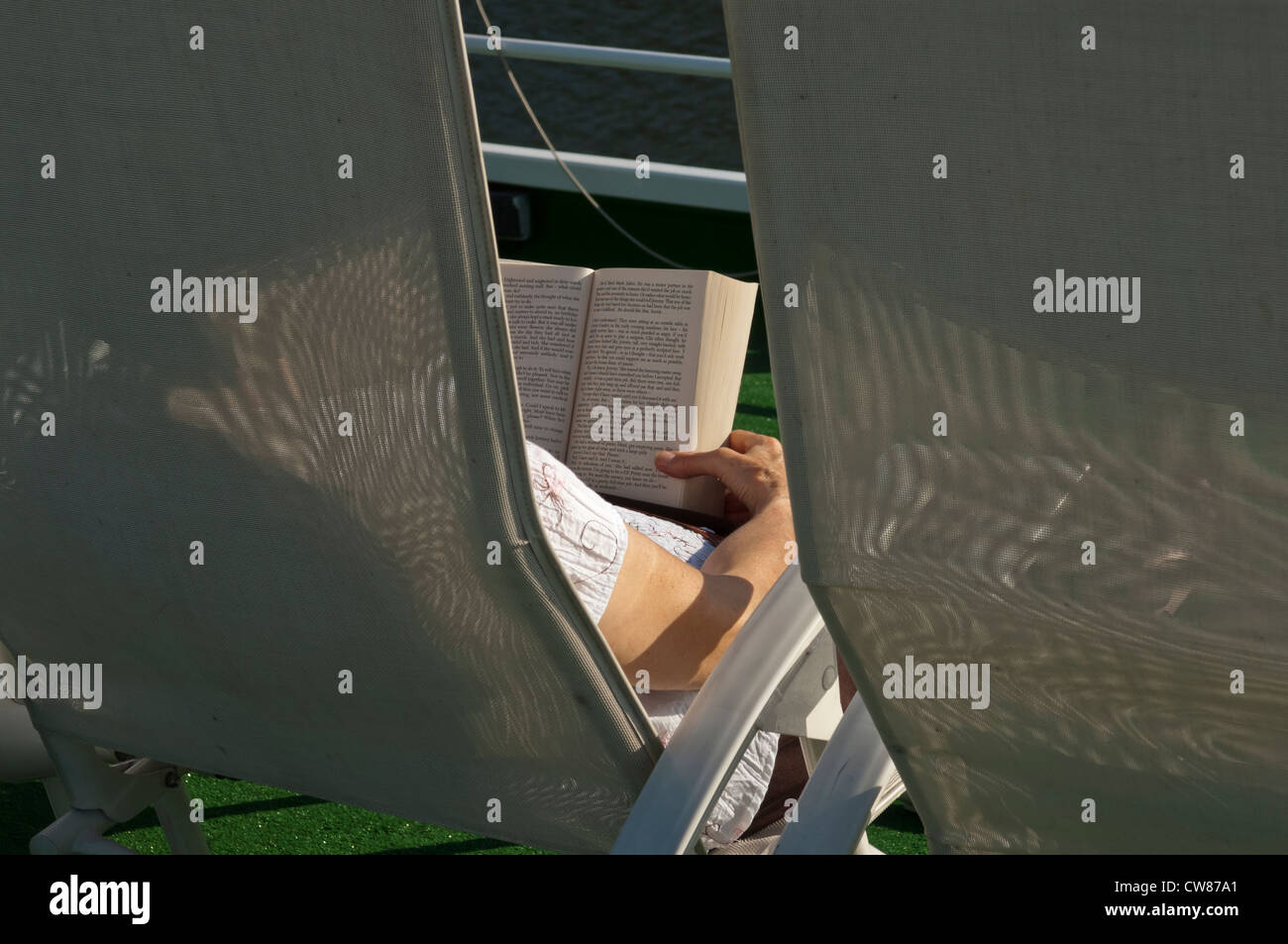 Cruise ship passenger reading book hi-res stock photography and images ...