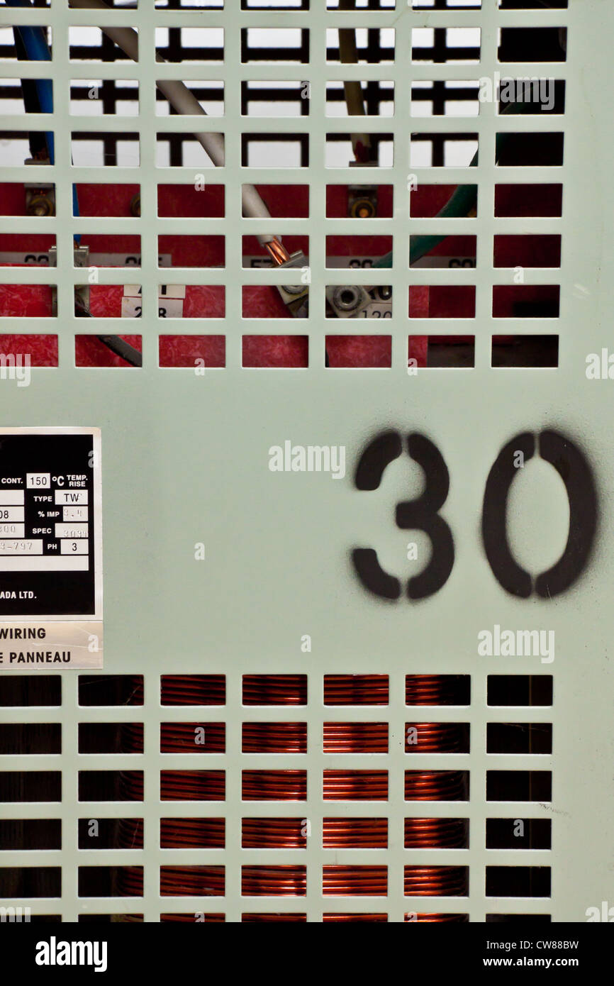 Industrial electric equipment detail with technical plate on a grill ...