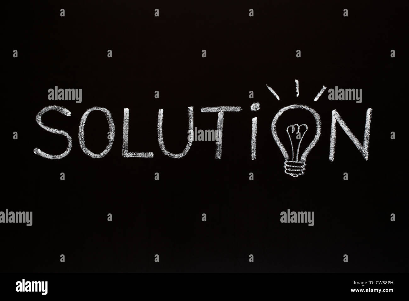 Solution concept with chalk drawn light bulb on the place of the letter ...