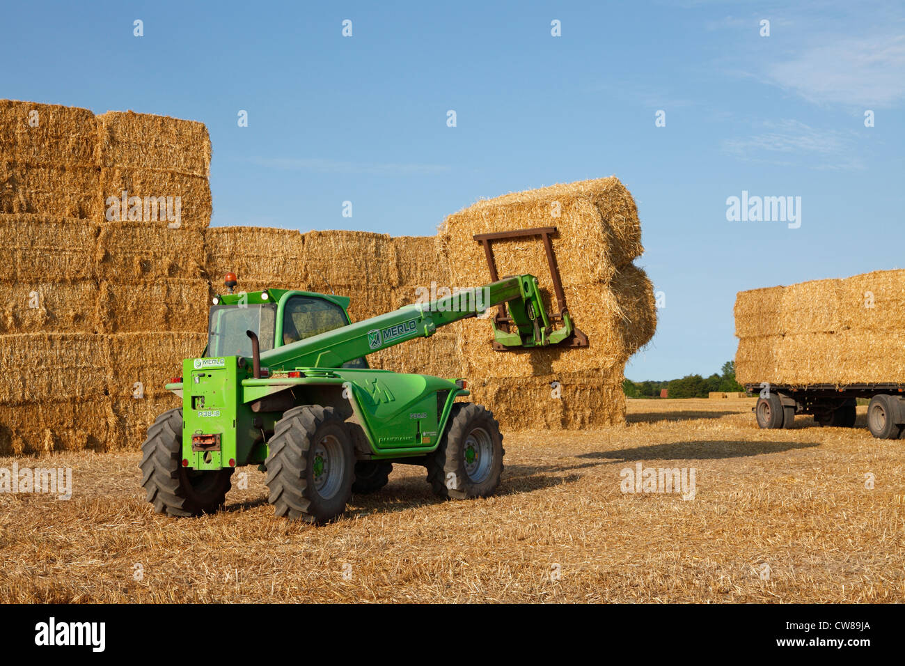 Turbofarmer lift stacking big straw bales on a field in Lynge, North ...