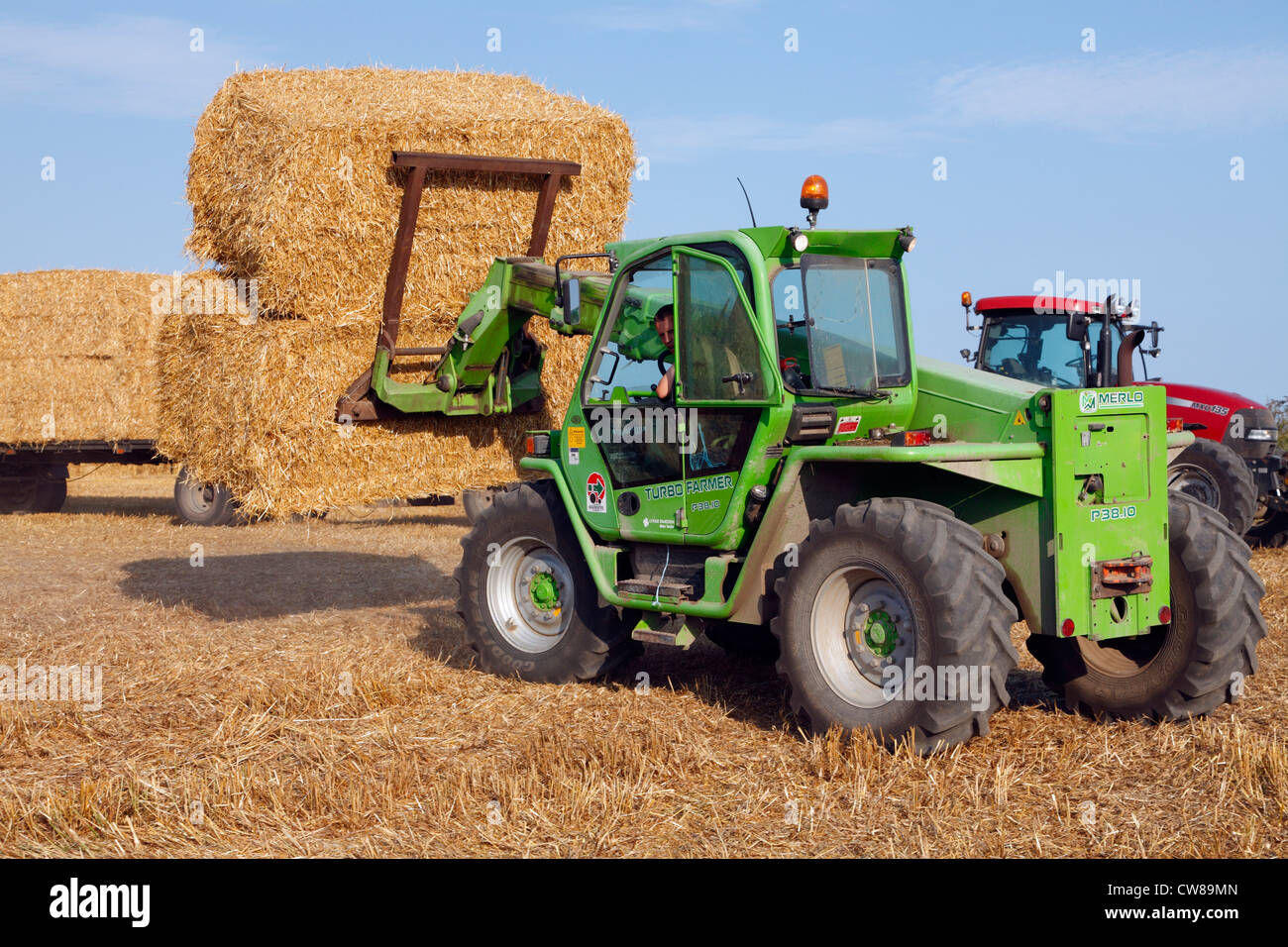 Turbofarmer lift stacking big straw bales on a field in Lynge, North ...